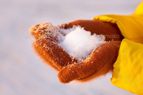 Snow in hands. Human hands in warm gloves with snow against snowy ...