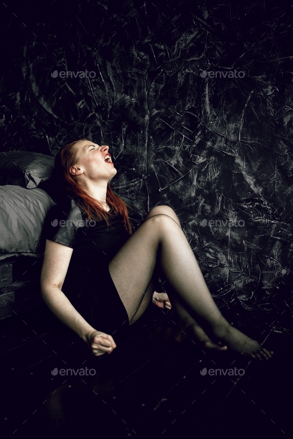 Young woman sitting on floor and crying aloud. Depression, despair ...