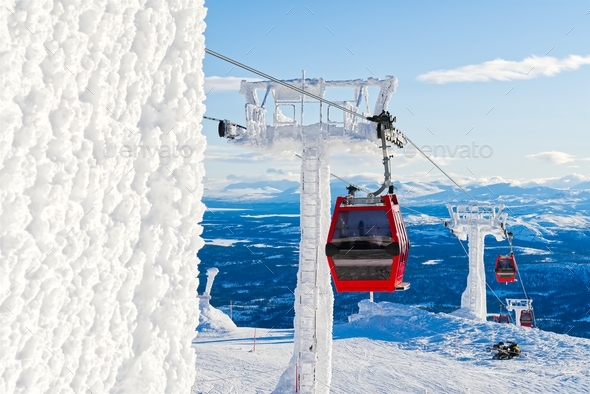Red cable car in a ski resort in the Alps. Red gondola funicular in a ...
