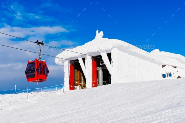 Red cable car in a ski resort in the Alps. Red gondola funicular in a ...