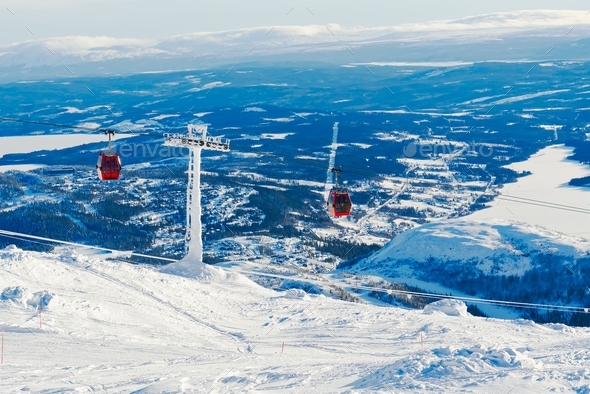Red cable car in a ski resort in the Alps. Red gondola funicular in a ...