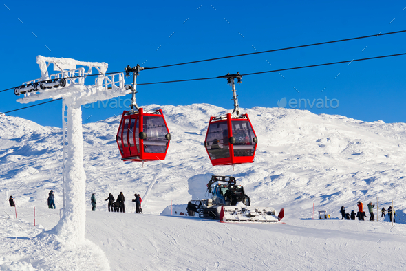 Red cable car in a ski resort in the Alps. Red gondola funicular in a ...