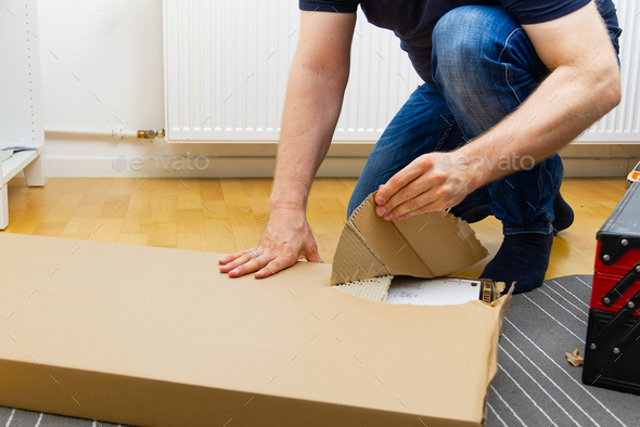 Professional Furniture Assembly Worker Assembles Shelf. Furniture ...