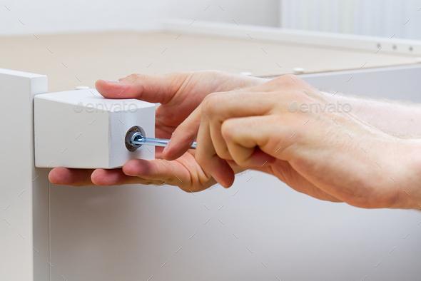 Professional Furniture Assembly Worker Assembles Shelf. Furniture ...