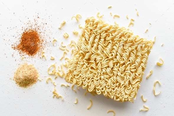 Instant noodles with seasonings on the table. Stock Photo by Maliflower73
