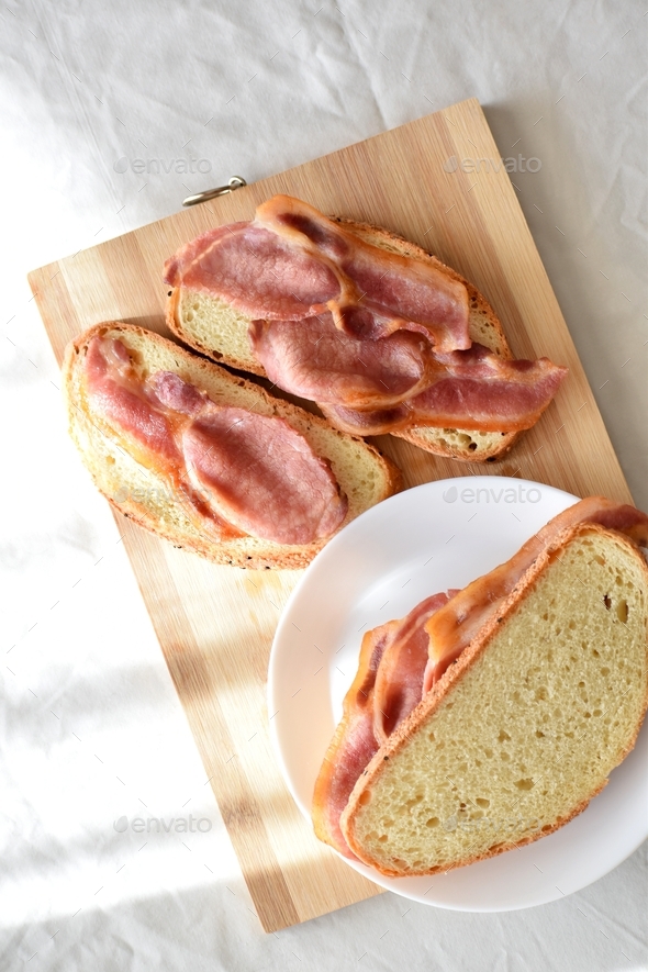 Back bacon sandwich on bamboo chopping board. Flat lay top view photo ...
