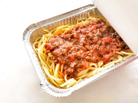 Spaghetti Bolognese in a aluminium foil tray. Food delivery and ...