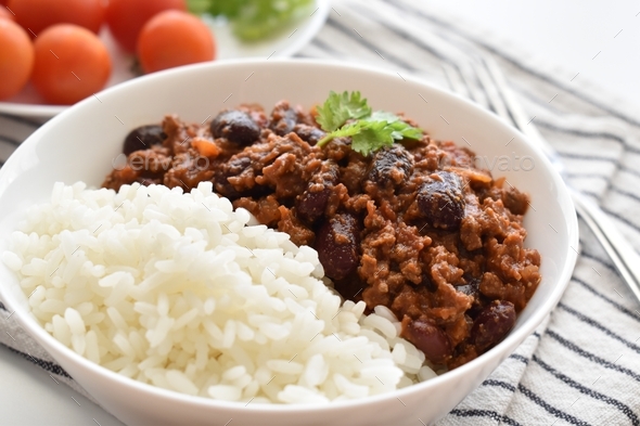 Chilli con carne with rice in a white bowl. Traditional Mexican food ...