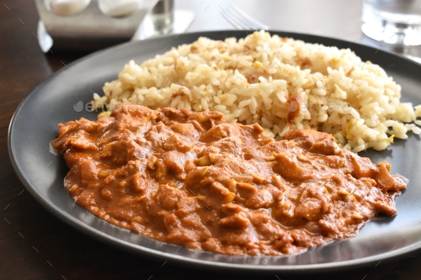Indian chicken curry with egg fried rice on a black plate. Stock Photo ...
