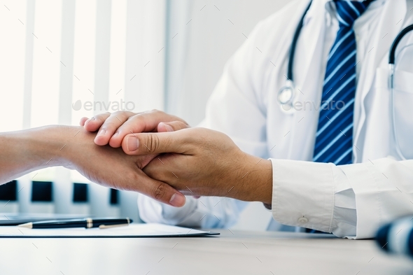 Doctor hands holding patient hand to encourage and explained the health ...