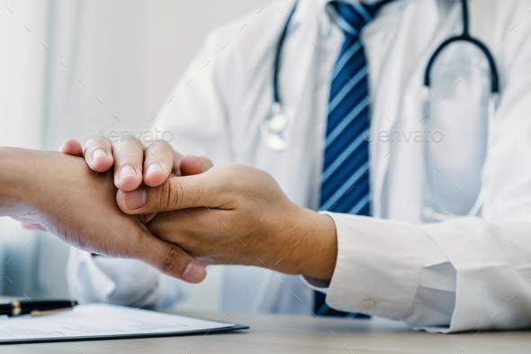 Doctor hands holding patient hand to encourage and explained the health ...