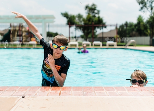 Children playing at the pool in the summer on a sunny day. Stock Photo ...