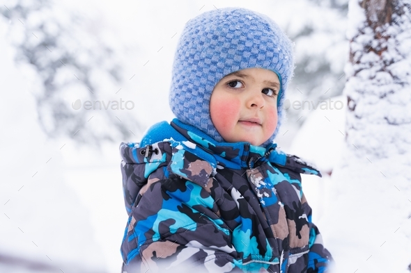 Little smiling cute boy. Red blush on cheeks.Kid walking in beautiful ...