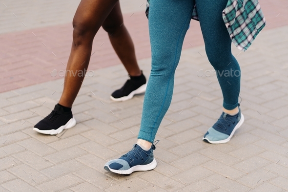 Two women legs jogging in the city. Sports, walking, training, healthy ...