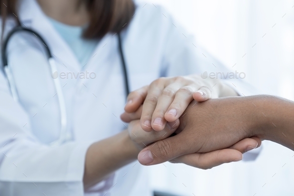 The doctor hands holding patient hand to encourage and explained the ...