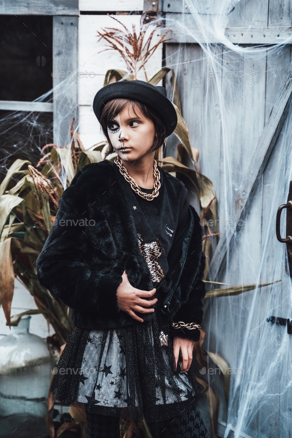 Beautiful scary little girl celebrating halloween. Terrifying black ...