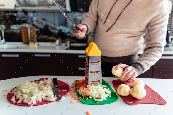 Cooking man, father, cooker. Preparation of soup, lunch, dinner in ...