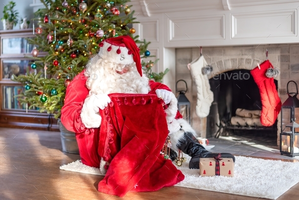 Santa getting presents out of his bag Stock Photo by krisprahl | PhotoDune