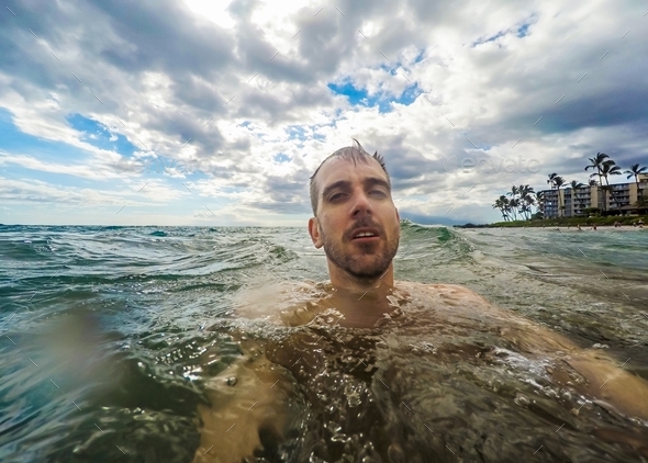 Man swimming far off shore of tropical island. Stock Photo by RLTheis