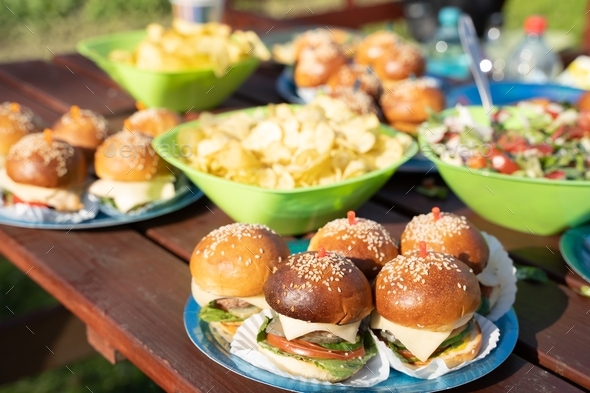 Buffet table with many mini burgers at outdoors birthday party for ...