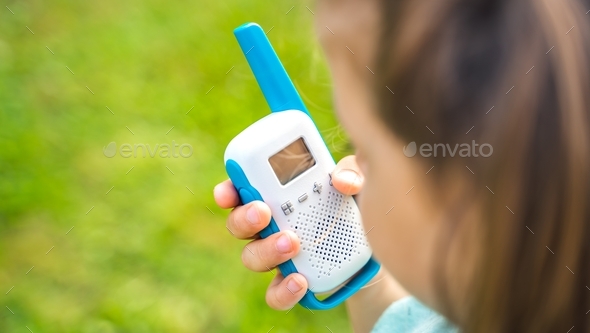 Small girl,kid play in walkie-talkie.Walkie Talkies with channels.Game ...
