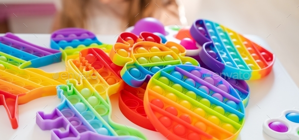 Little girl,kid,child plays with colorful pop it children's room ...