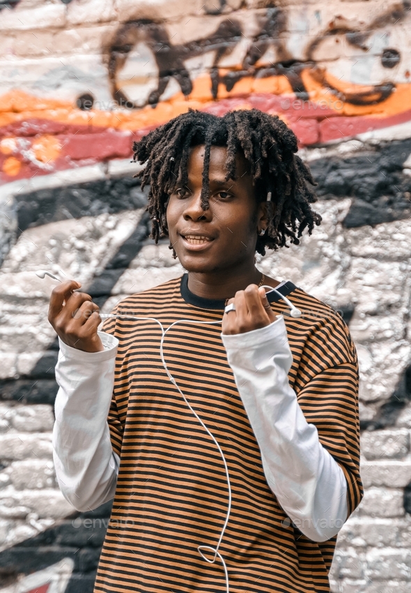 Portrait of young handsome dancing stylish black man with natural hair ...