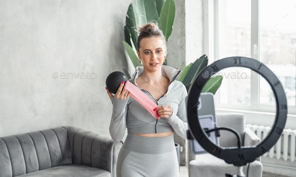 Young sporty slim woman yoga coach, female fitness instructor records ...