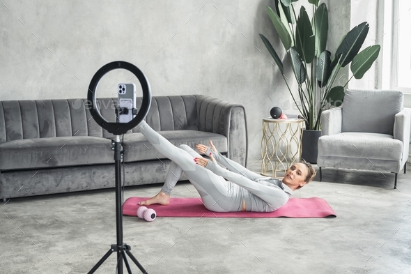 Young sporty slim woman yoga coach, female fitness instructor records ...