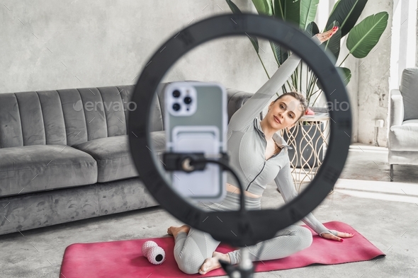 Young sporty slim woman yoga coach, female fitness instructor records ...