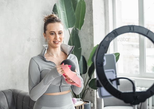 Young sporty slim woman yoga coach, female fitness instructor records ...