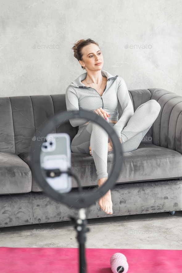 Young sporty slim woman yoga coach, female fitness instructor records ...