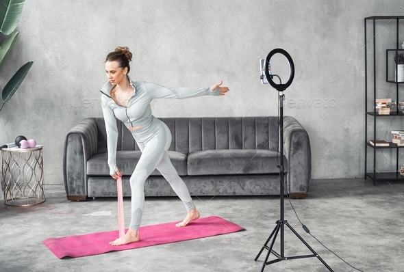 Young sporty slim woman yoga coach, female fitness instructor records ...