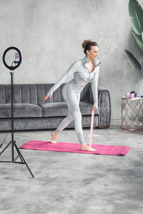 Young sporty slim woman yoga coach, female fitness instructor records ...