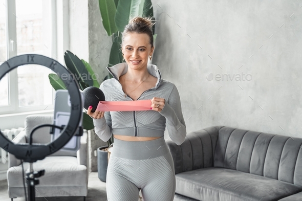 Young sporty slim woman yoga coach, female fitness instructor records ...