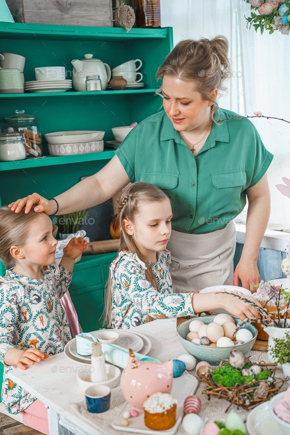 Family, mom girls at table with decoration for Easter celebration in ...