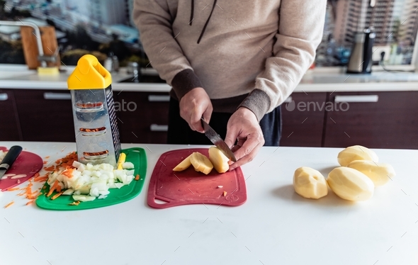 Cooking man, father, cooker. Preparation of soup, lunch, dinner in ...