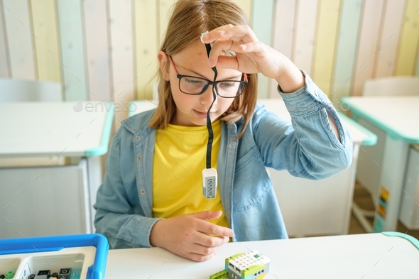 Programming work for robotics in elementary school. Children girls students assembly, launch ...