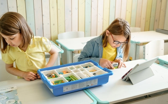 Programming work for robotics in elementary school. Children girls students assembly, launch ...