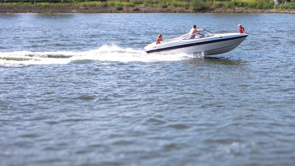 Family fun on the water with the speed boat. Stock Photo by SmitBruins