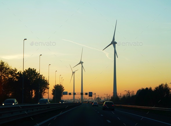 Traffic, windmills along the highway, on the golden hour Stock Photo by ...