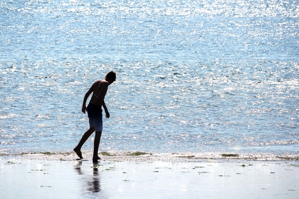 Boy walking on the beachside Stock Photo by SmitBruins | PhotoDune