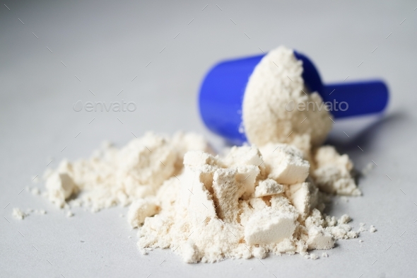 Scoop of the whey protein powder spilled on the white background. Stock ...