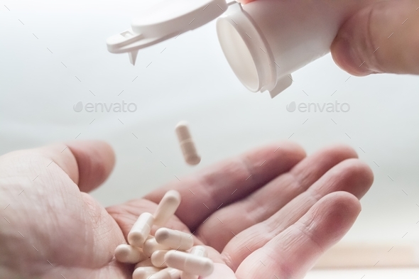 Pills dropping in hand taking medication, covid19 paxlovid medicine ...
