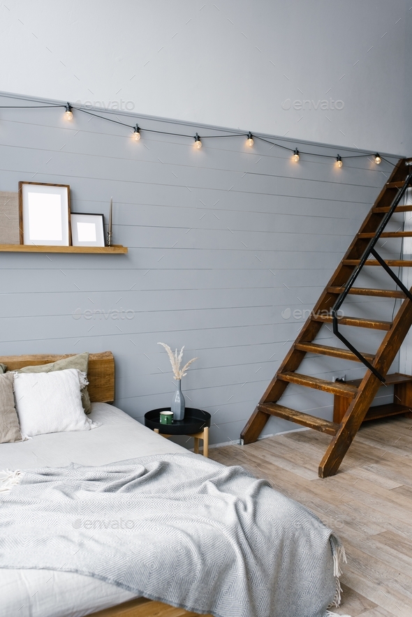 Stylish Scandinavian open space with a bed and stairs to the second ...