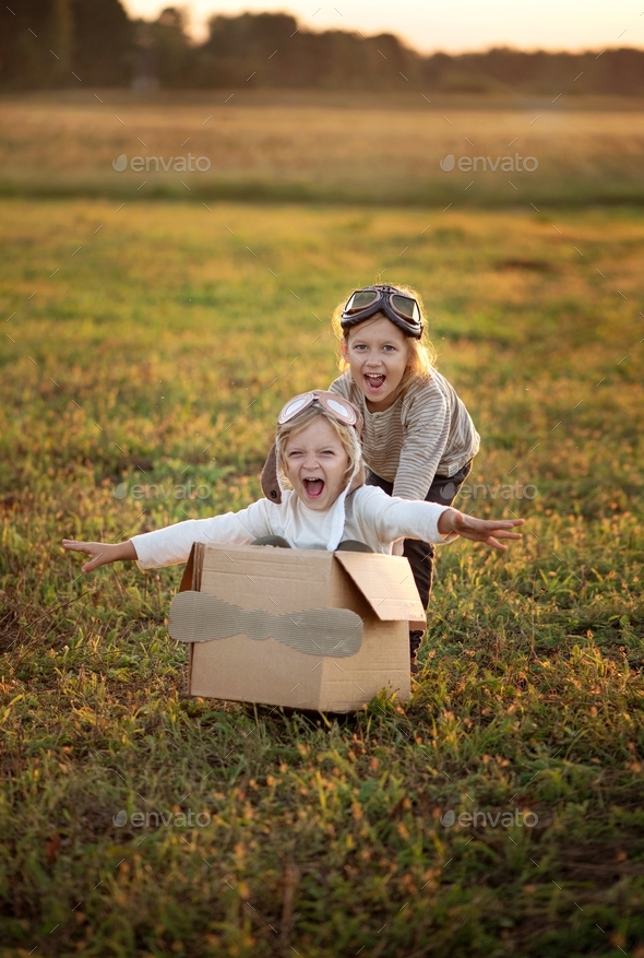 Girls in pilot suits play in the field Stock Photo by katrinasid ...