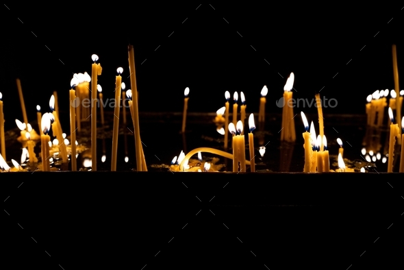 Lit church candles in the temple. Stock Photo by katrinasid | PhotoDune