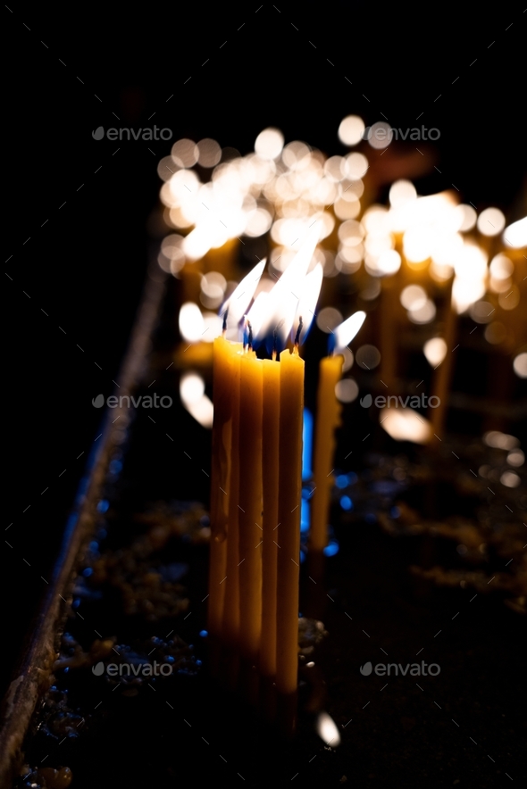 Lit church candles in the temple. Stock Photo by katrinasid | PhotoDune