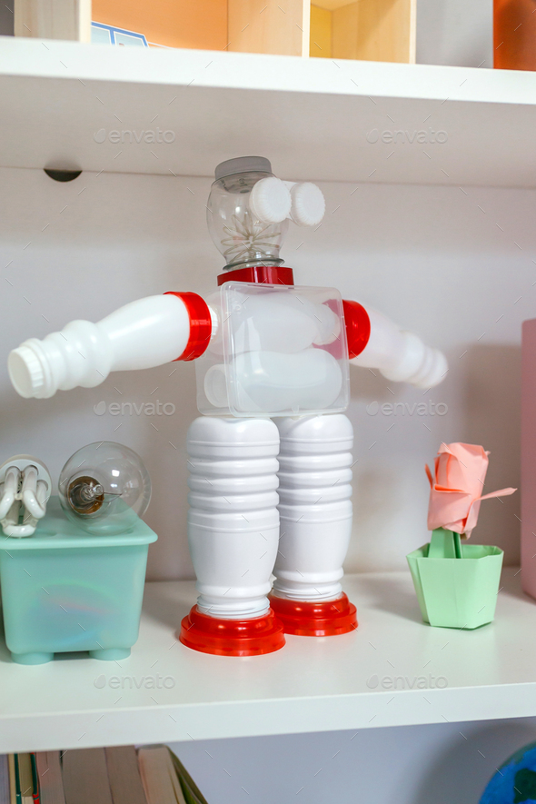 Recycled toy robot made with plastic packages on shelf in classroom ...