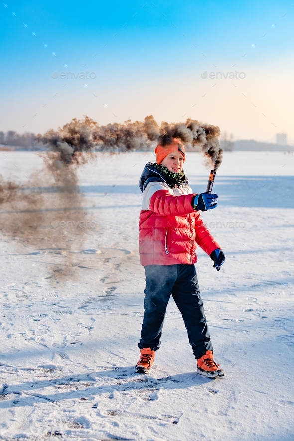 Boy with black smoke grenade in his hands Stock Photo by irynachubarova